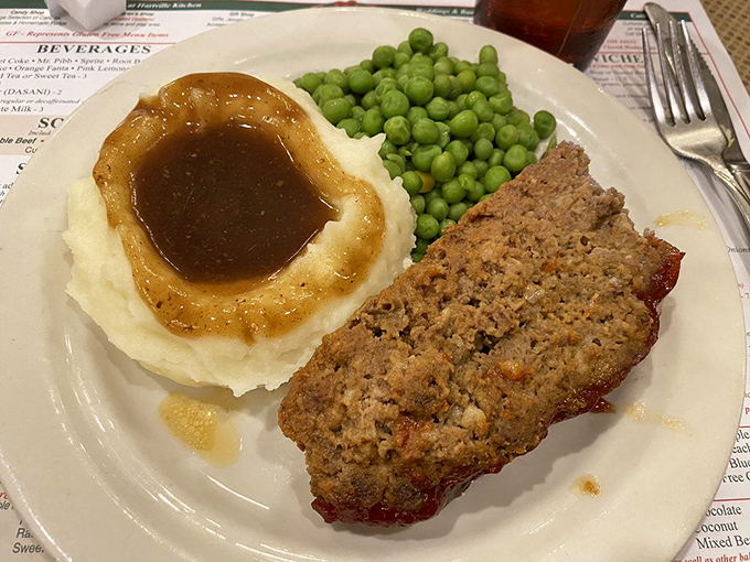 Meatloaf that would make your grandmother both proud and jealous, served with those iconic crater-topped mashed potatoes that practically beg for gravy.
