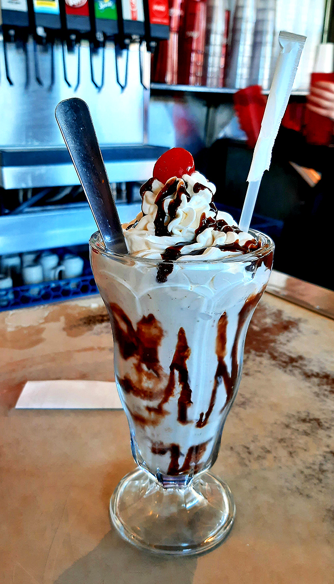 This isn't just a milkshake – it's a tower of creamy nostalgia topped with enough whipped cream to make your inner child do backflips.