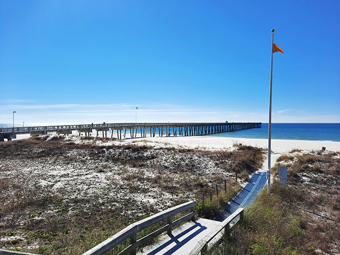 A pier stretches toward the horizon like nature's own runway, inviting you to strut your stuff toward the emerald waters beyond.