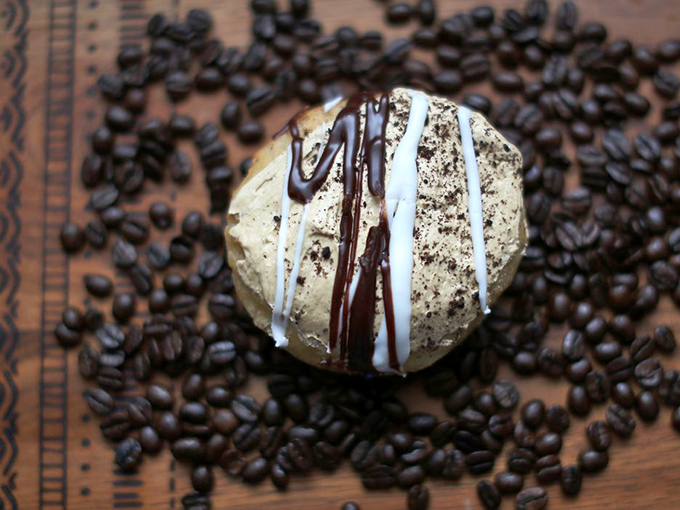 Coffee beans frame this mocha masterpiece like a halo, proving some marriages really are made in heaven.