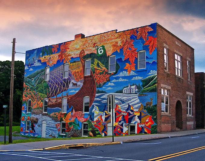 Mount Jewett's spectacular heritage mural transforms a simple brick building into a vibrant canvas celebrating the town's Swedish roots and natural splendor.