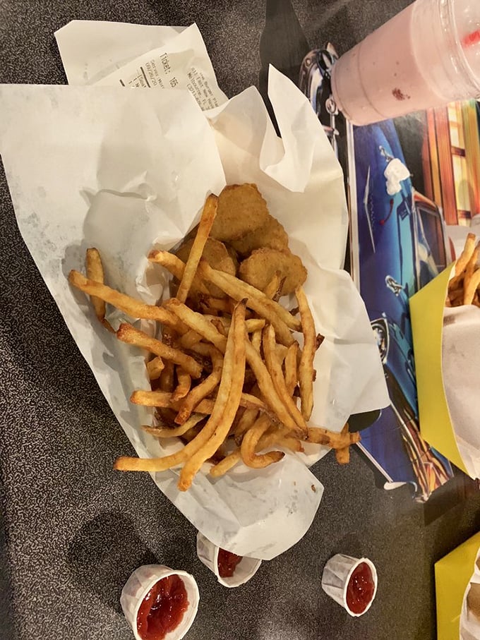 French fries and chicken nuggets: the dynamic duo of comfort food, served unpretentiously in paper-lined baskets as the culinary gods intended.