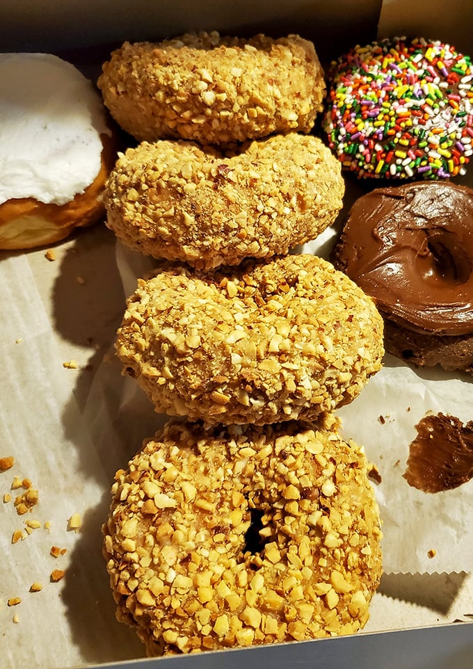 Peanut-topped donuts that would make Elvis weep, alongside chocolate glazed perfection and rainbow sprinkles for the kid in all of us.