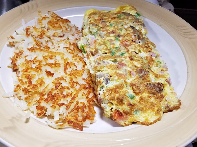This omelet doesn't just sit on the plate&mdash;it commands attention with perfectly folded eggs alongside hash browns crisped to golden perfection.