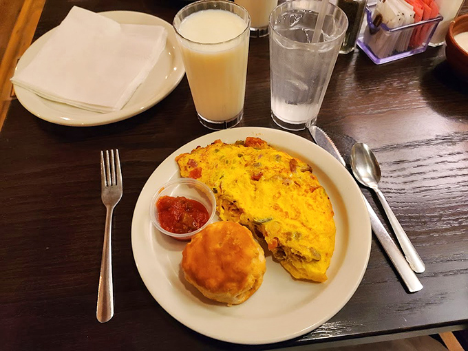 Breakfast perfection on a plate: a fluffy omelet that didn't come from a carton, a biscuit that would make grandma proud, and salsa for those morning flavor adventurers.