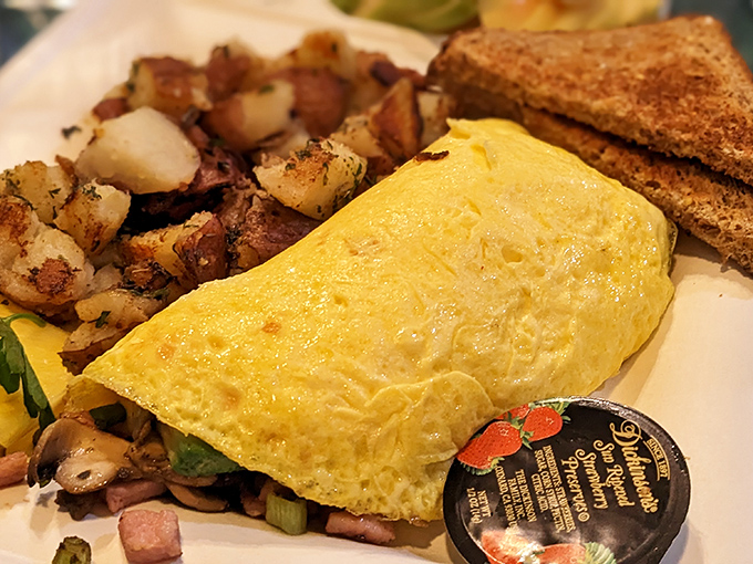 This omelet doesn't just sit on the plate—it commands attention, stuffed with fillings and paired with potatoes that achieved the perfect crisp-tender balance.