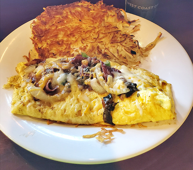 This loaded omelet is a masterpiece of morning indulgence, paired with a crispy hash brown patty that's worth its weight in gold.