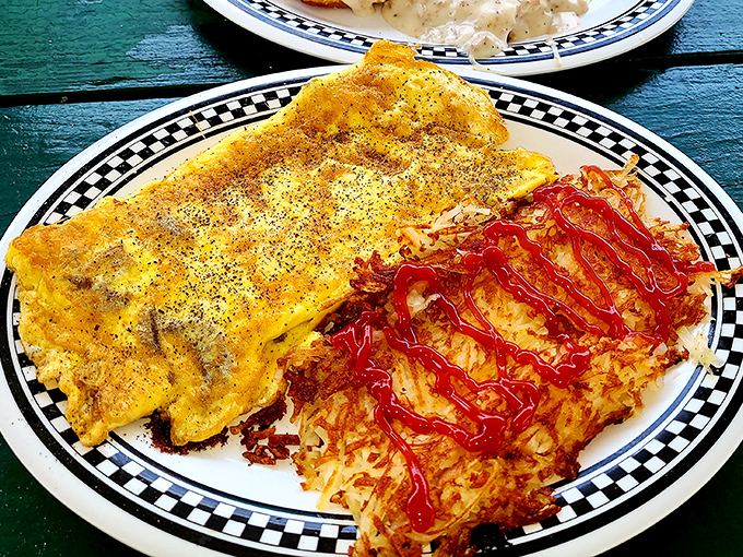 Omelets shouldn't be this photogenic, but here we are. That golden perfection with hash browns drizzled with ketchup is breakfast nirvana, Florida-style.