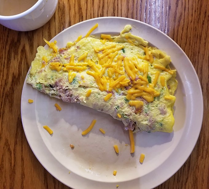 This isn't just an omelet&mdash;it's a cheese-crowned celebration of morning possibilities, folded with the precision of origami but the comfort of a warm hug.