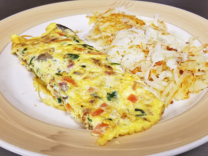 This omelet doesn't just sit on the plate &ndash; it commands respect. Perfectly executed with crispy edges and a side of hash browns that could make a potato farmer weep with pride.