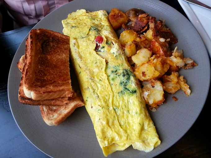 This isn't just an omelet&mdash;it's breakfast architecture. Fluffy eggs folded over fillings with the precision of an origami master.