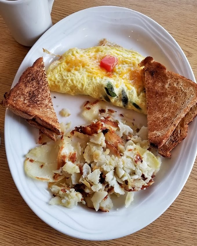 This omelet doesn't just sit on the plate&mdash;it commands attention with melted cheese and perfectly crisped potatoes standing guard.