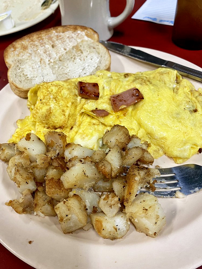 This isn't just an omelet&mdash;it's a golden canvas of perfectly cooked eggs cradling ham and potatoes with the tenderness of a lullaby.