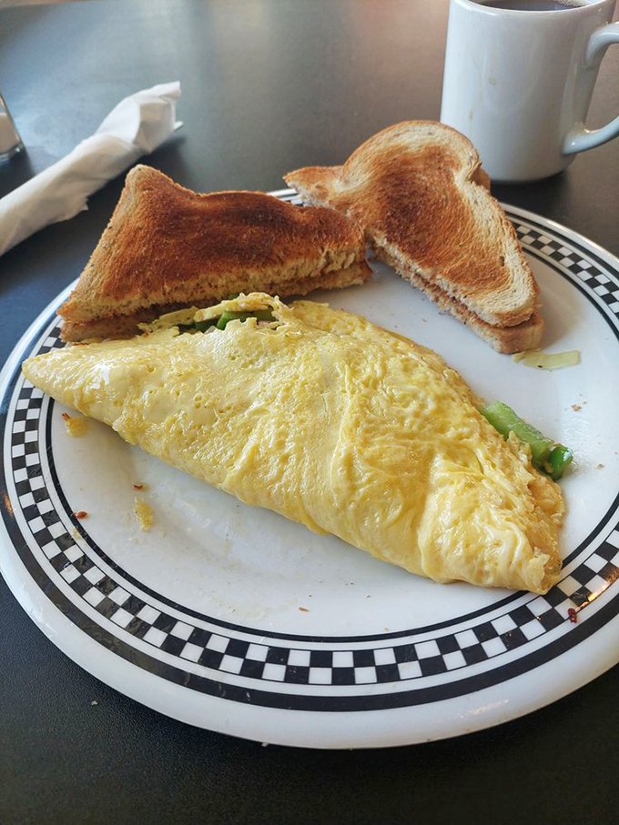 This omelet isn't trying to impress food critics; it's too busy making regular folks happy with its perfect fold and generous filling.