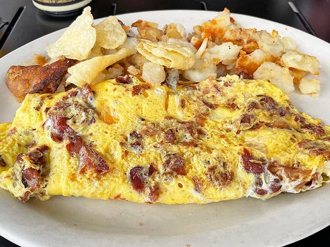 This isn't just any omelet &ndash; it's breakfast architecture, where bacon and cheese create a masterpiece that makes morning meetings worth postponing.