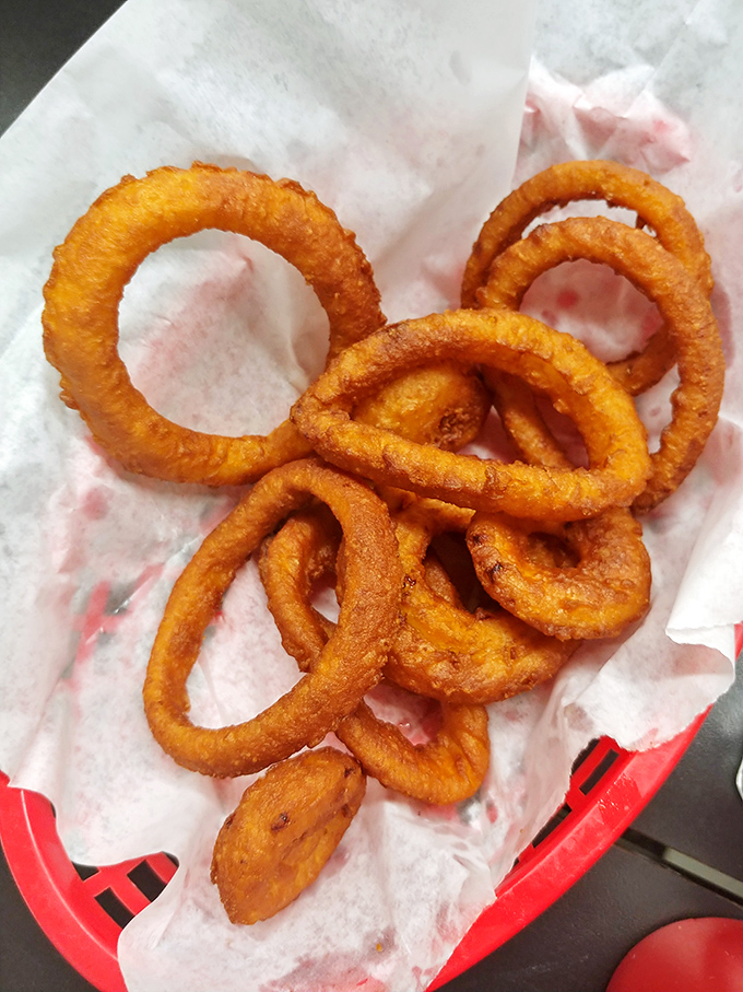 The legendary onion rings in their natural habitat&mdash;golden, crispy perfection that makes you wonder if you've been settling for mediocrity your entire life.