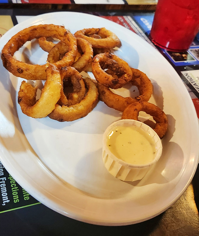 These onion rings aren't just appetizers&mdash;they're golden halos of happiness with a side of creamy dipping sauce for your dunking pleasure.