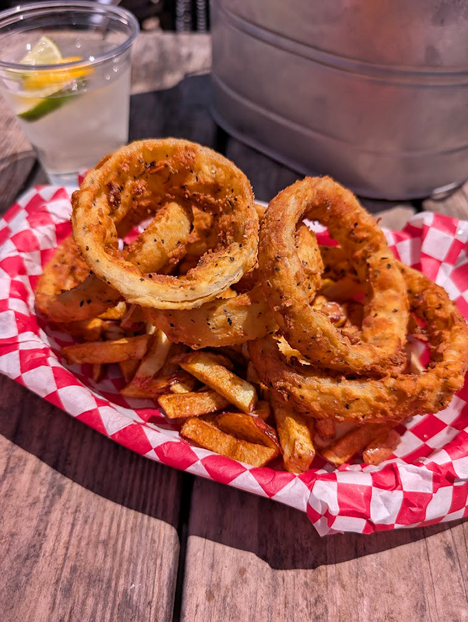 Golden onion rings that shatter with each bite, paired with hand-cut fries&mdash;proof that the supporting cast at Alamo Springs deserves their own standing ovation.