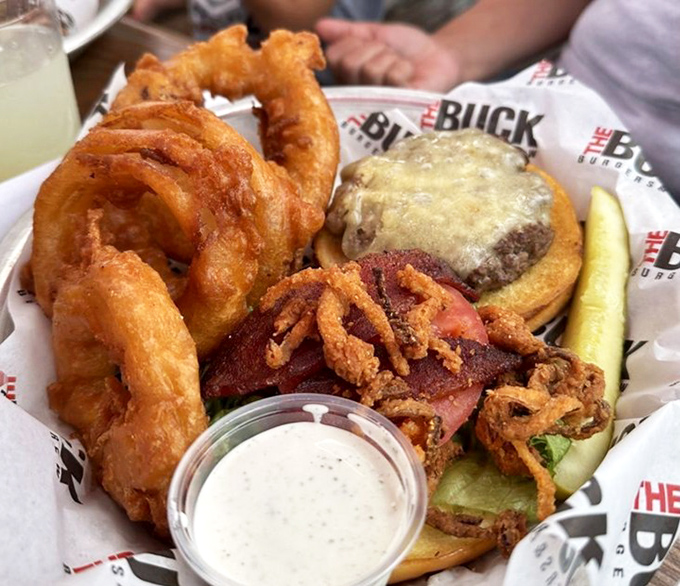 These aren't just onion rings; they're golden halos of crispy perfection. The kind that make you forget your table manners as you reach for "just one more."