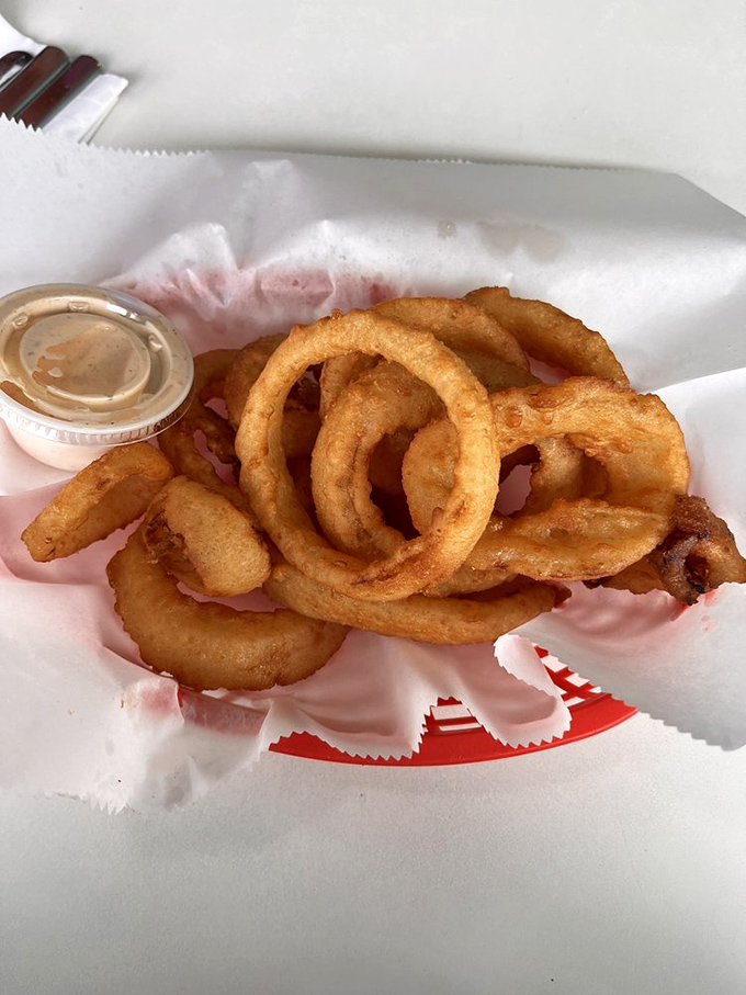 Onion rings that crunch loud enough to turn heads. Golden, perfectly seasoned circles of joy that make you wonder why vegetables ever bothered growing any other shape.