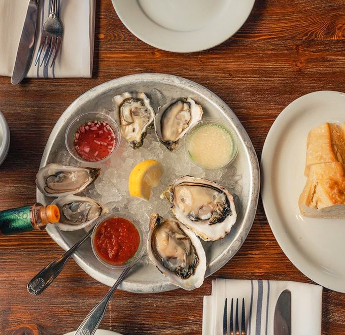 Fresh oysters arrive on ice like oceanic gems, each one a briny kiss from the Pacific's depths.