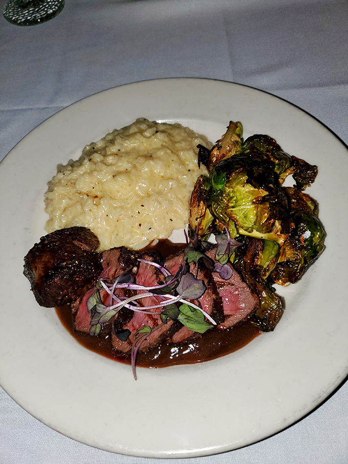 Perfectly seared elk medallions nestled against creamy risotto and charred Brussels sprouts&mdash;proof that frontier food has come a long way since jerky.