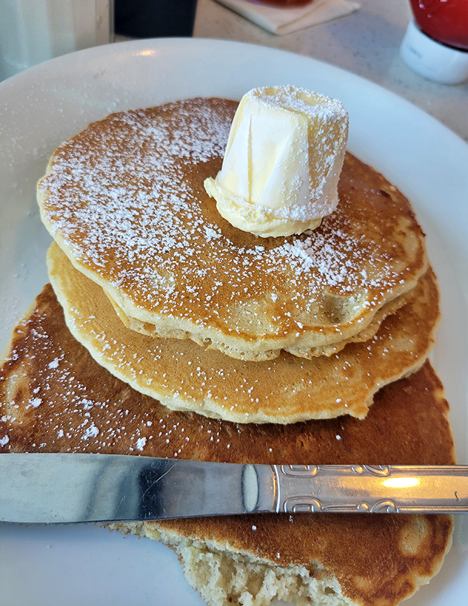 These pancakes aren't just breakfast, they're an engineering marvel&mdash;fluffy platforms perfectly designed to support that glorious butter crown and powdered sugar snowfall.