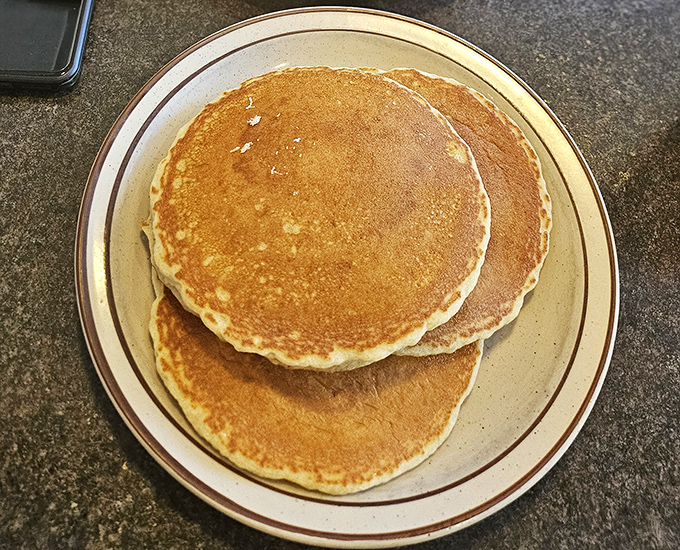 Golden pancakes that look like they've been practicing for their food magazine photoshoot &ndash; fluffy, perfectly round, and ready for their maple syrup bath.