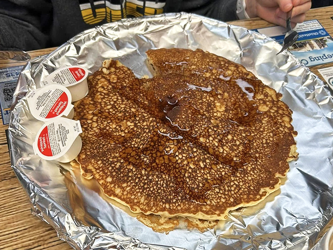 Pancakes so perfectly golden they deserve their own Olympic medal. Served on foil because paper plates would simply surrender to this magnificent stack.