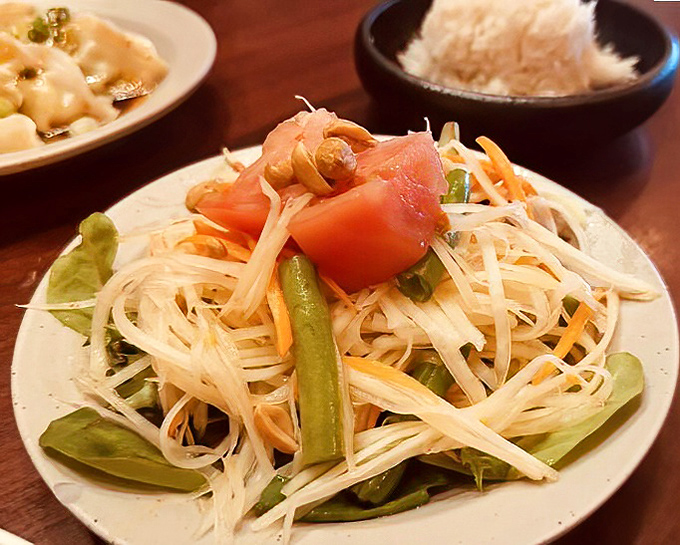 A papaya salad that dances between sweet, sour, and spicy &ndash; like a perfectly choreographed flavor ballet on a pristine white plate.