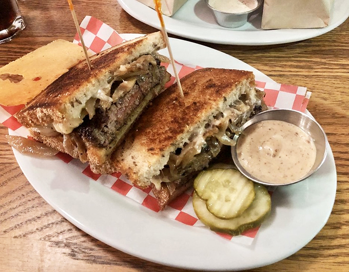 The patty melt arrives like a work of art&mdash;crispy rye bread, melted cheese, and beef in perfect harmony, with pickles standing by for moral support.