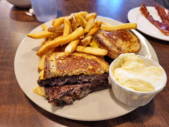 The patty melt&mdash;that perfect marriage of beef, melted cheese, and grilled bread&mdash;served with fries that somehow stay crispy until the last bite.