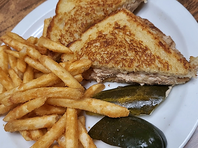 This golden-grilled patty melt isn't just a sandwich&mdash;it's a masterclass in the art of comfort food, complete with the mandatory pickle garnish.