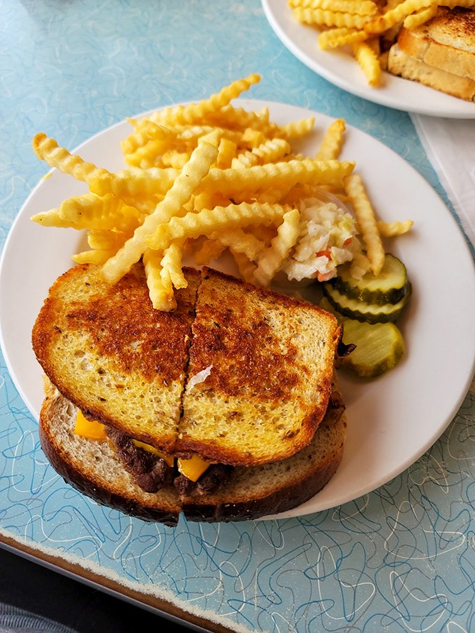 This patty melt isn't just a sandwich; it's a masterclass in comfort food engineering, complete with perfectly golden bread and melty cheese.