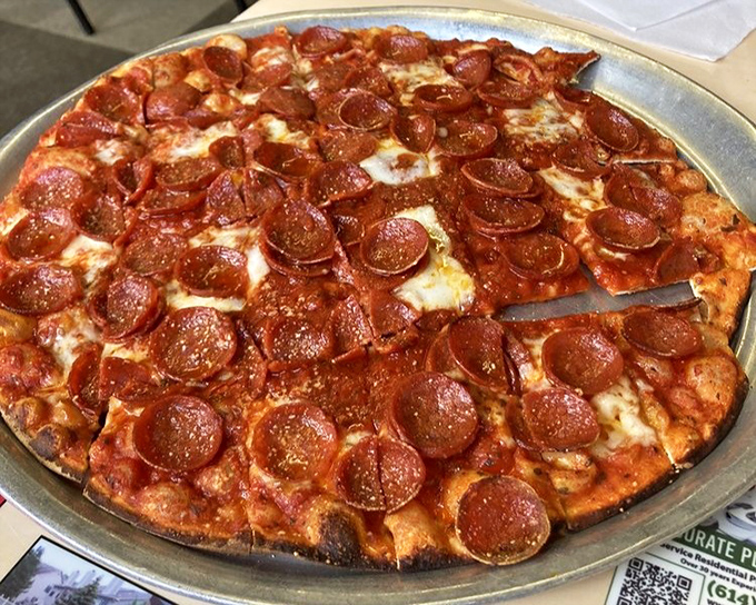 This pepperoni pizza isn't trying to impress Instagram—it's trying to impress your taste buds with perfectly crisped edges and that distinctive square-cut Ohio style.