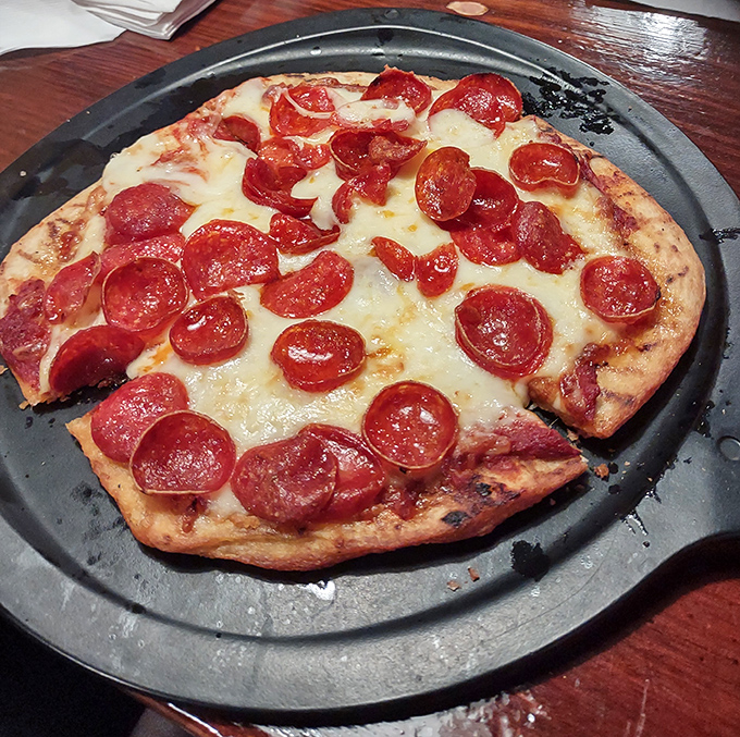 This isn't just pizza – it's a crispy, cheesy canvas where each pepperoni curls into a tiny flavor bowl. Simple perfection on a plate.