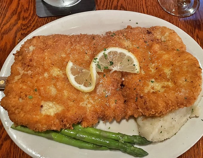 The Perkinsville Pork arrives golden and crisp, with lemon slices perched atop like sunshine, proving Indiana knows more than just corn and basketball.