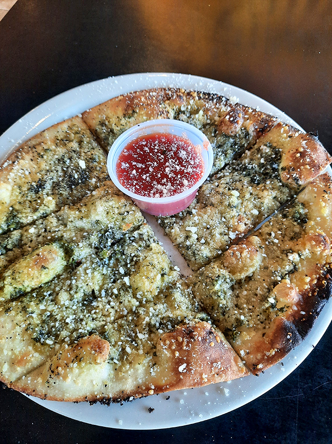 Pesto bread that makes garlic bread look like it's not even trying, with that center cup of marinara waiting like a flavor jackpot.