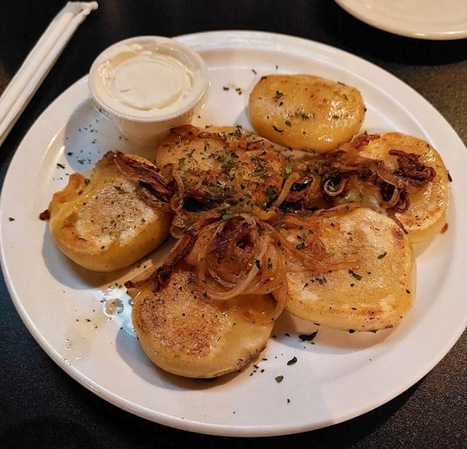 These pierogis aren't just food; they're little potato pillows of happiness, glistening with butter and onions in a display of Midwestern comfort perfection.