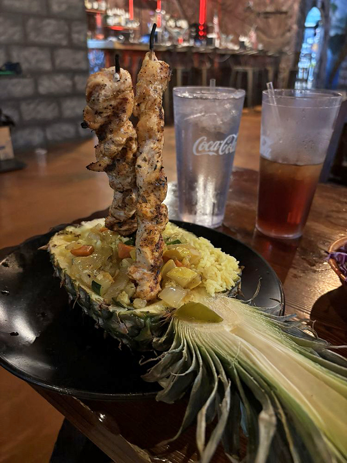 Skewered chicken served in a hollowed pineapple boat &ndash; because regular plates are for restaurants without dinosaurs on the roof.