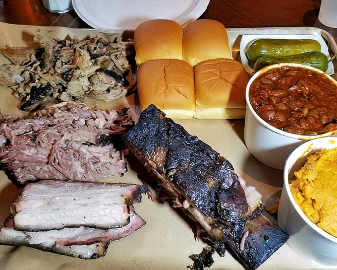 A barbecue feast fit for royalty – where pulled pork, ribs, and brisket share space with rolls, pickles and beans in perfect harmony.