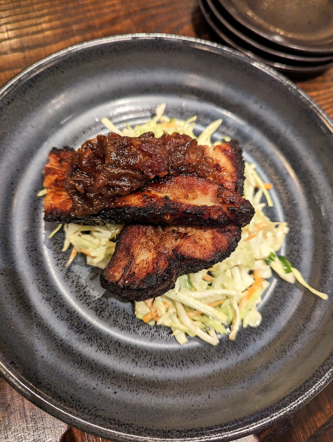 Pork belly: where bacon goes to dream bigger. This smoky-sweet masterpiece resting on crisp slaw is Kansas City's answer to fine dining.