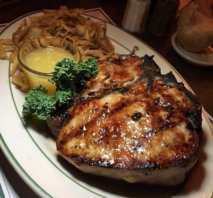 The pork chop arrives like a heavyweight champion &ndash; substantial, commanding respect, and paired with onion rings that could make you forget potatoes exist.