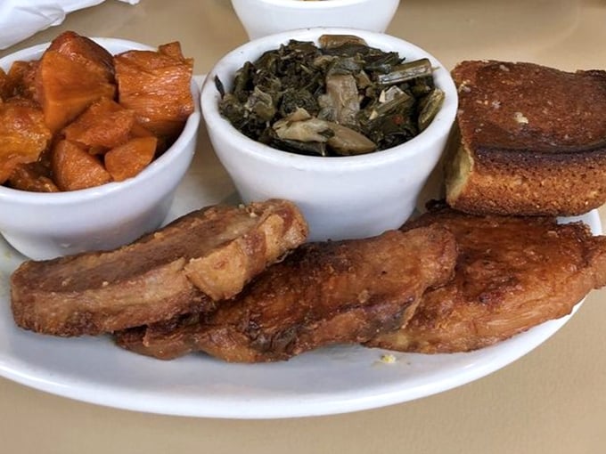 Soul food's greatest hits on one plate: pork chops, candied yams, and collard greens that taste like they've been simmering since Sunday morning church.
