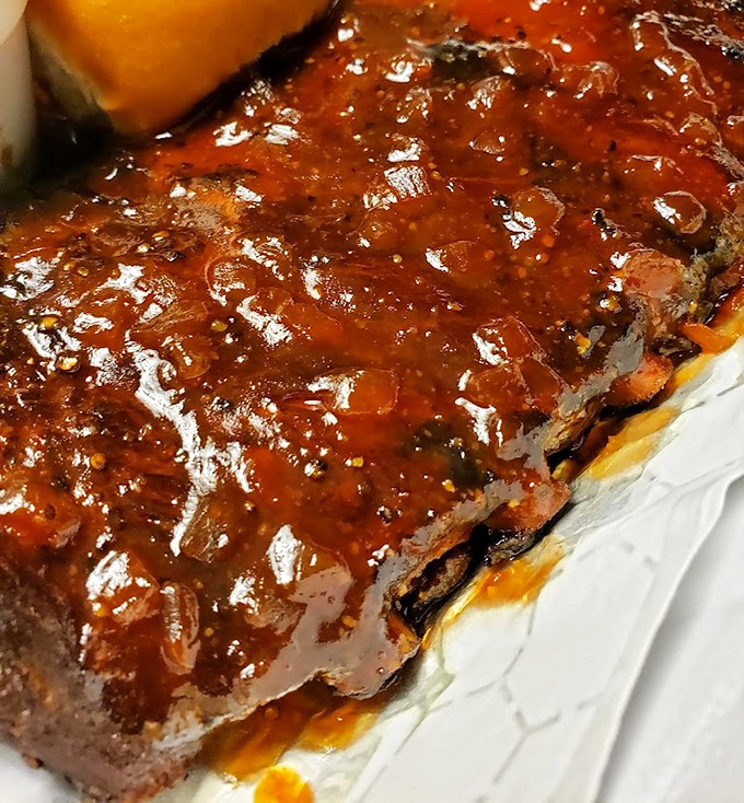 These ribs aren't just falling off the bone &ndash; they're practically jumping into your mouth, glistening with that signature sauce that balances sweet and tangy.