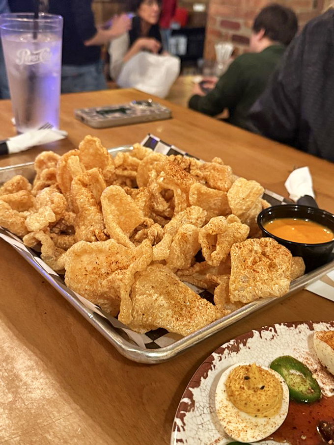 Pork rinds that shatter with satisfying crispness – the potato chip's more sophisticated, protein-packed cousin that pairs perfectly with cold beer.