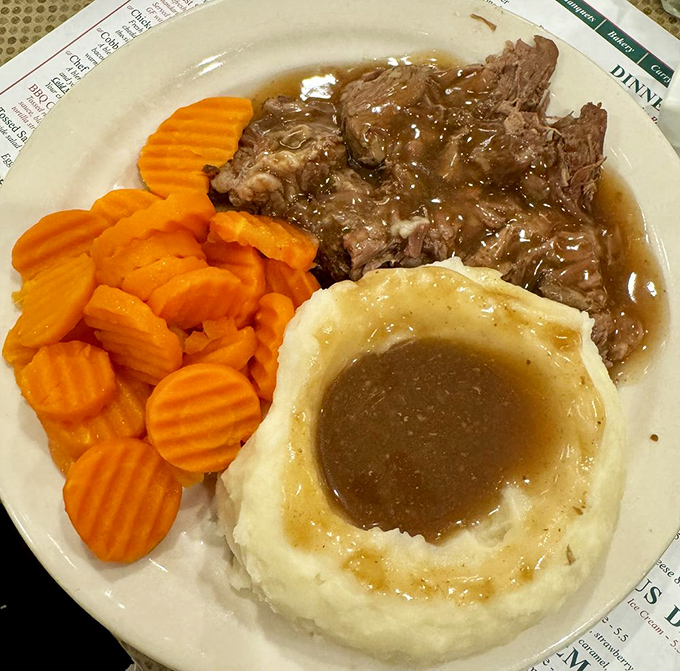 The holy trinity of comfort food: fork-tender pot roast, cloud-like mashed potatoes, and carrots that actually taste like carrots should.