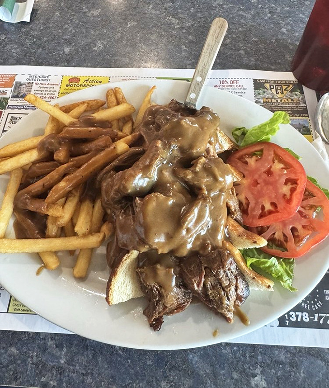 The hot roast beef sandwich&mdash;where gravy isn't just a condiment, it's a commitment. Those fries aren't just soaking it up, they're celebrating in it.
