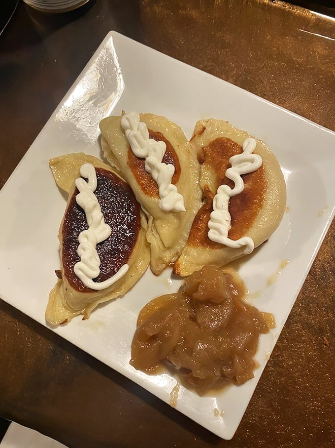 Golden-brown potato cheddar pierogies drizzled with sour cream and paired with caramelized onions. Carbs have never looked this seductive.