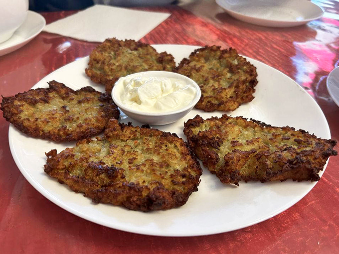 Golden-brown potato pancakes with crispy edges that would make your grandmother weep with joy. The sour cream is non-negotiable.